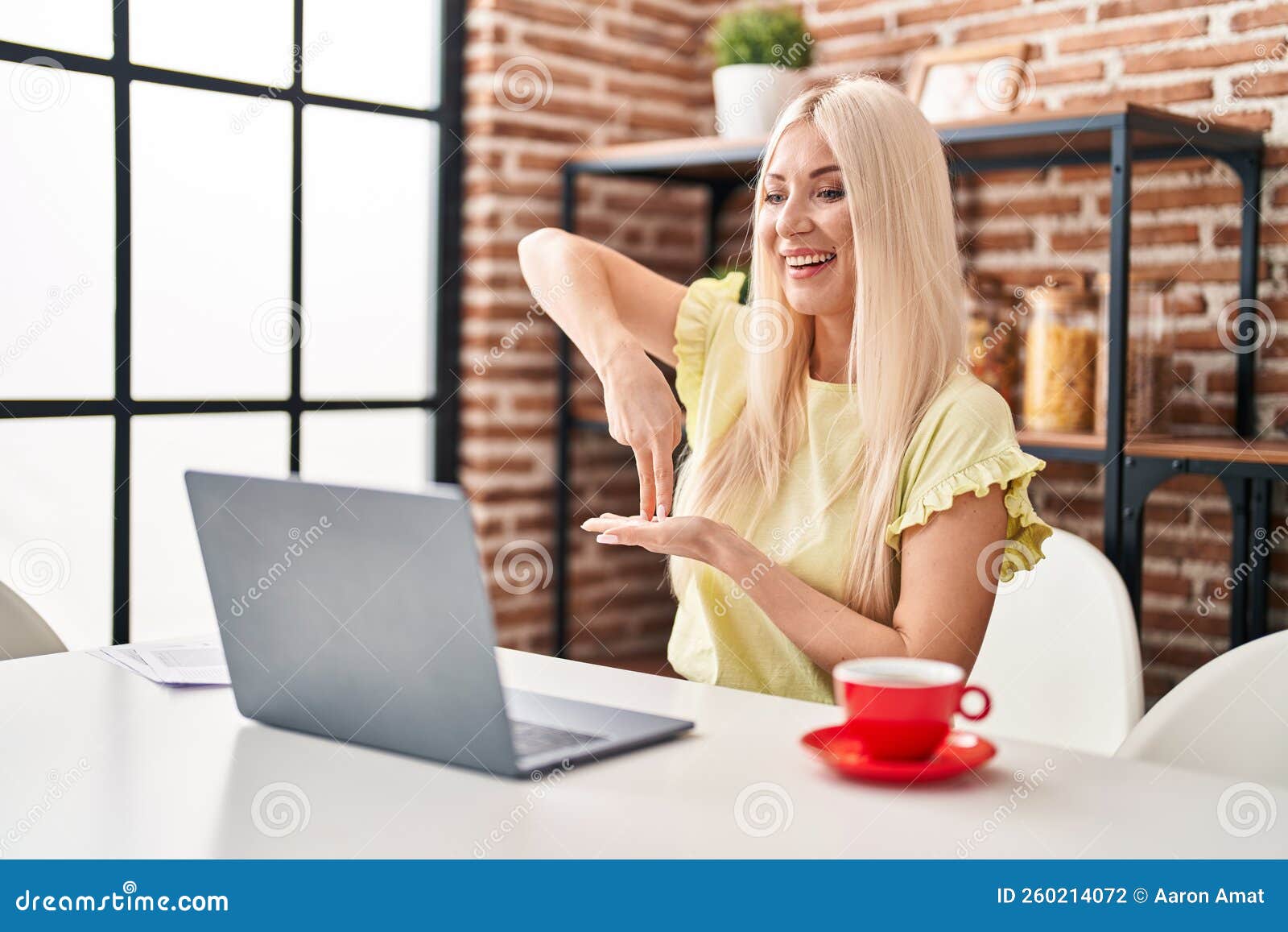 Young Blonde Woman Having Video Call Using Deaf Language at Home Stock ...