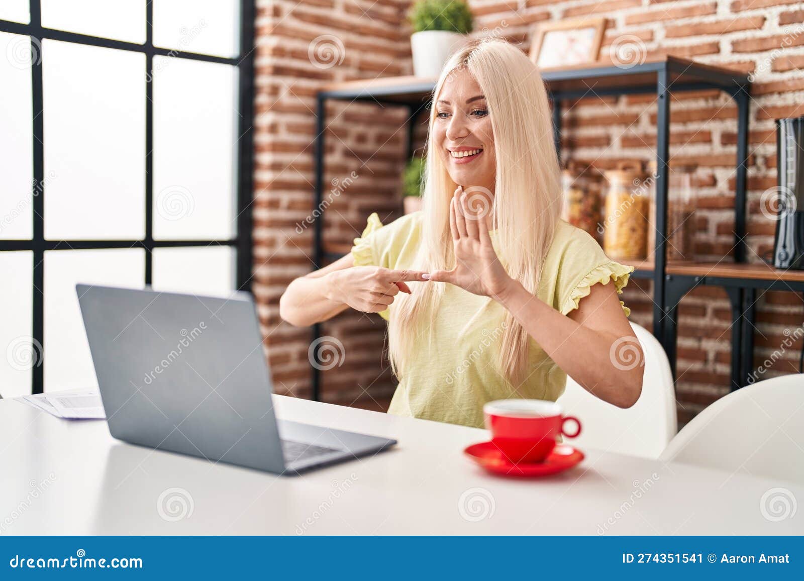 Young Blonde Woman Having Video Call Using Deaf Language at Home Stock ...