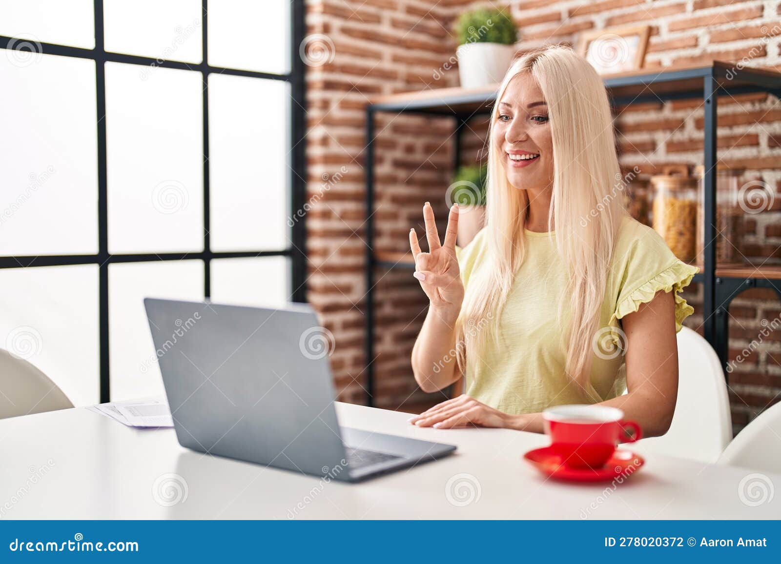 Young Blonde Woman Having Video Call Using Deaf Language at Home Stock ...