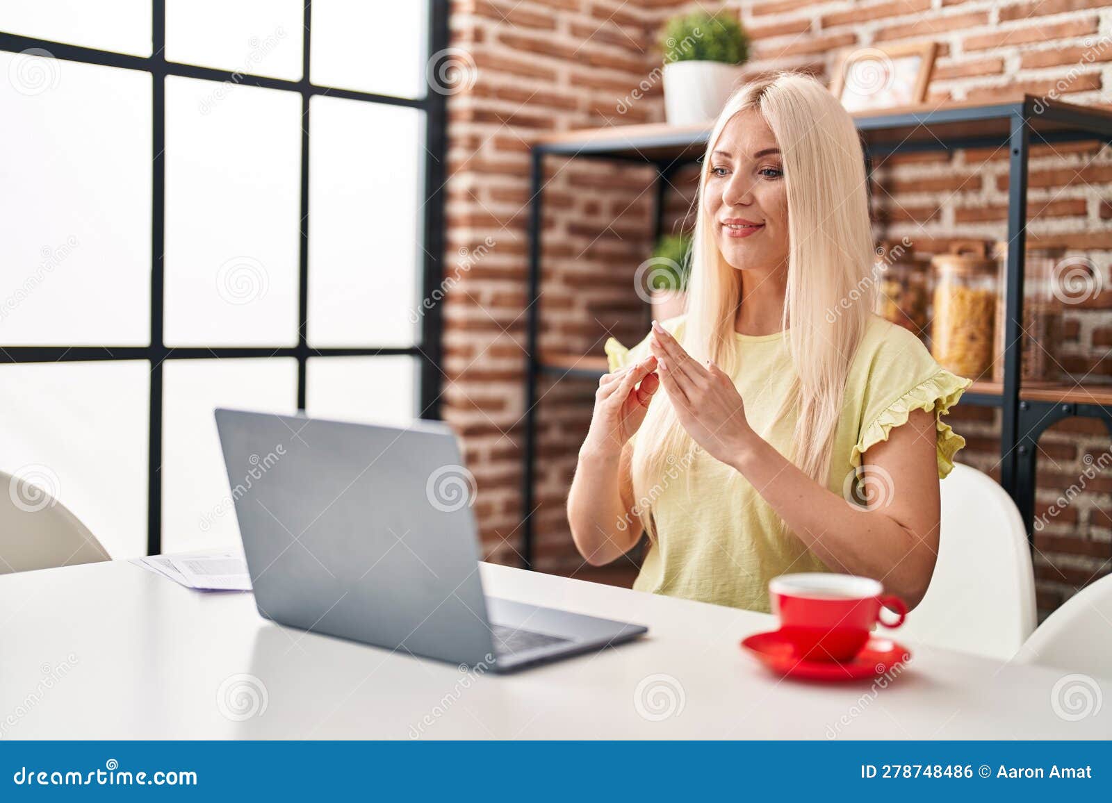 Young Blonde Woman Having Video Call Using Deaf Language at Home Stock ...