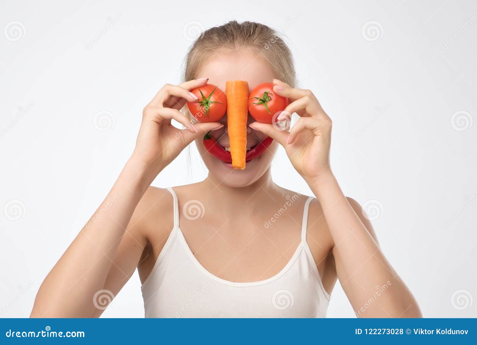 Young Blonde Woman Holding Vegetables Like it is Her Face. Stock Photo ... Young Blonde Woman Holding Vegetables Like it is Her Face. Stock Photo ...