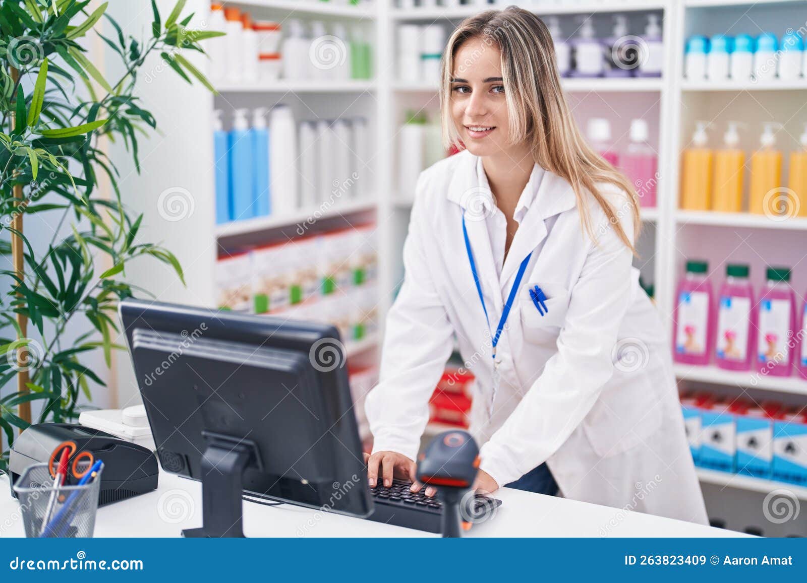 Young Blonde Woman Pharmacist Smiling Confident Using Computer at ...