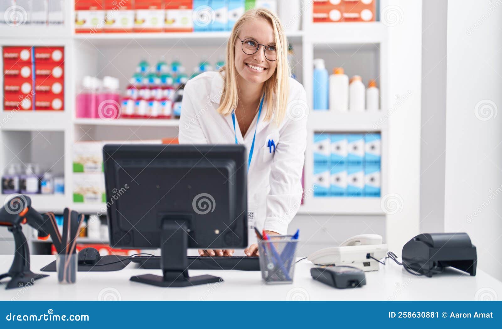 Young Blonde Woman Pharmacist Using Computer Working at Pharmacy Stock ...