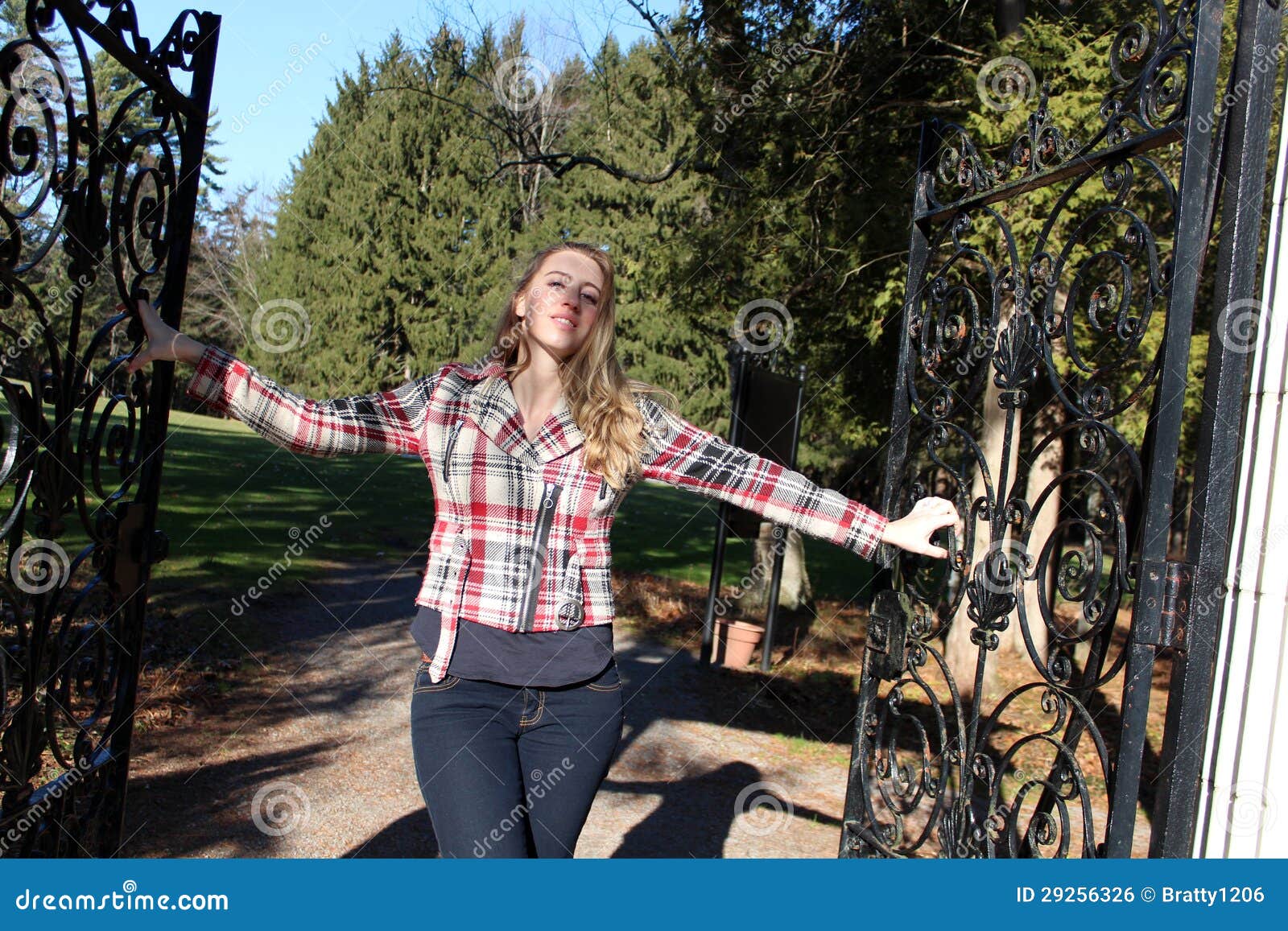 Young Blonde Woman Standing at Open Gates Stock Photo - Image of ...