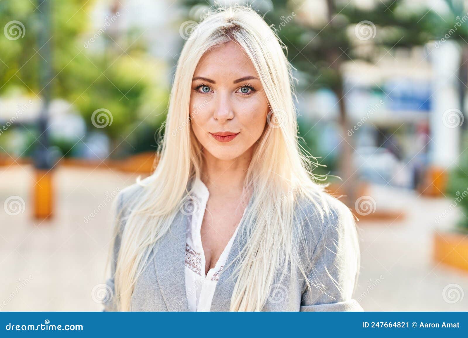 Young Blonde Woman Standing with Relaxed Expression at Park Stock Image ...