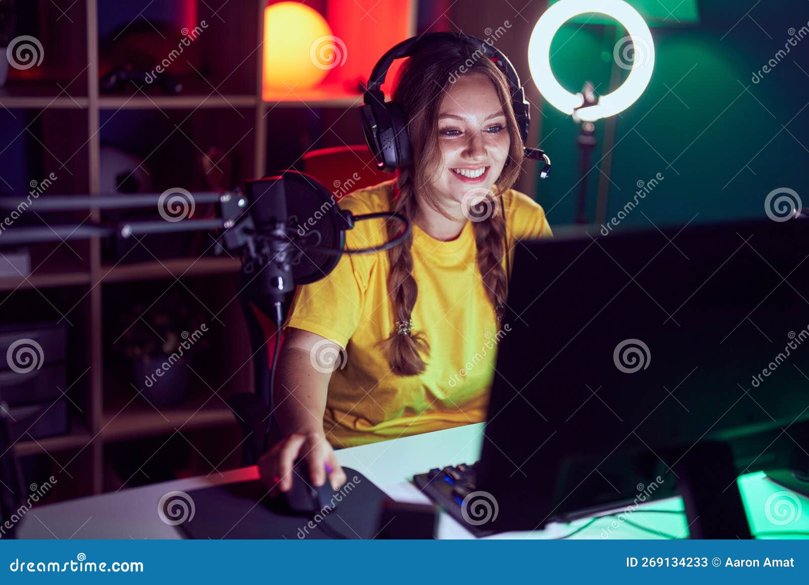 Young Blonde Woman Streamer Playing Video Game Using Computer at Gaming ...