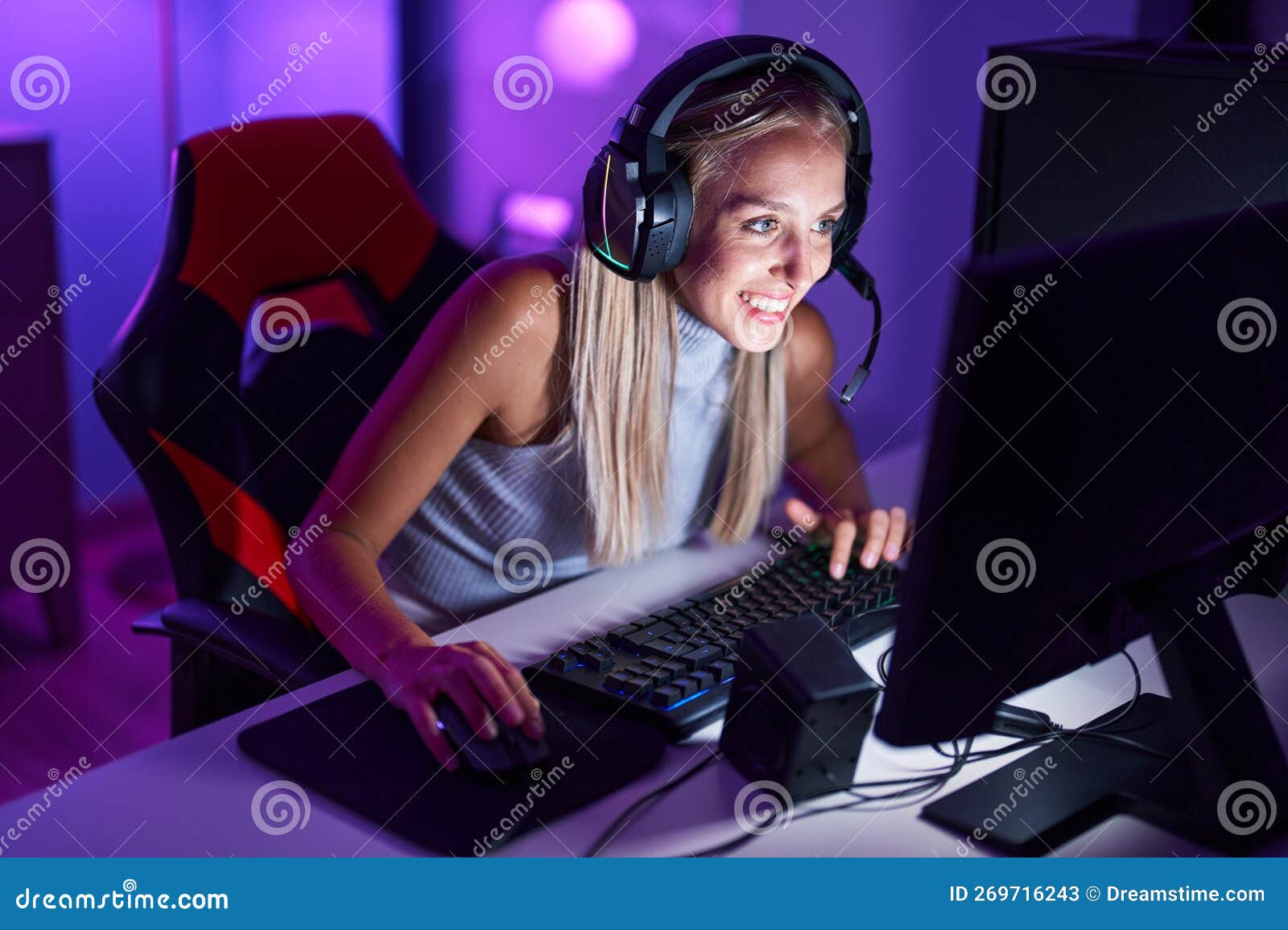 Young Blonde Woman Streamer Playing Video Game Using Computer at Gaming ...