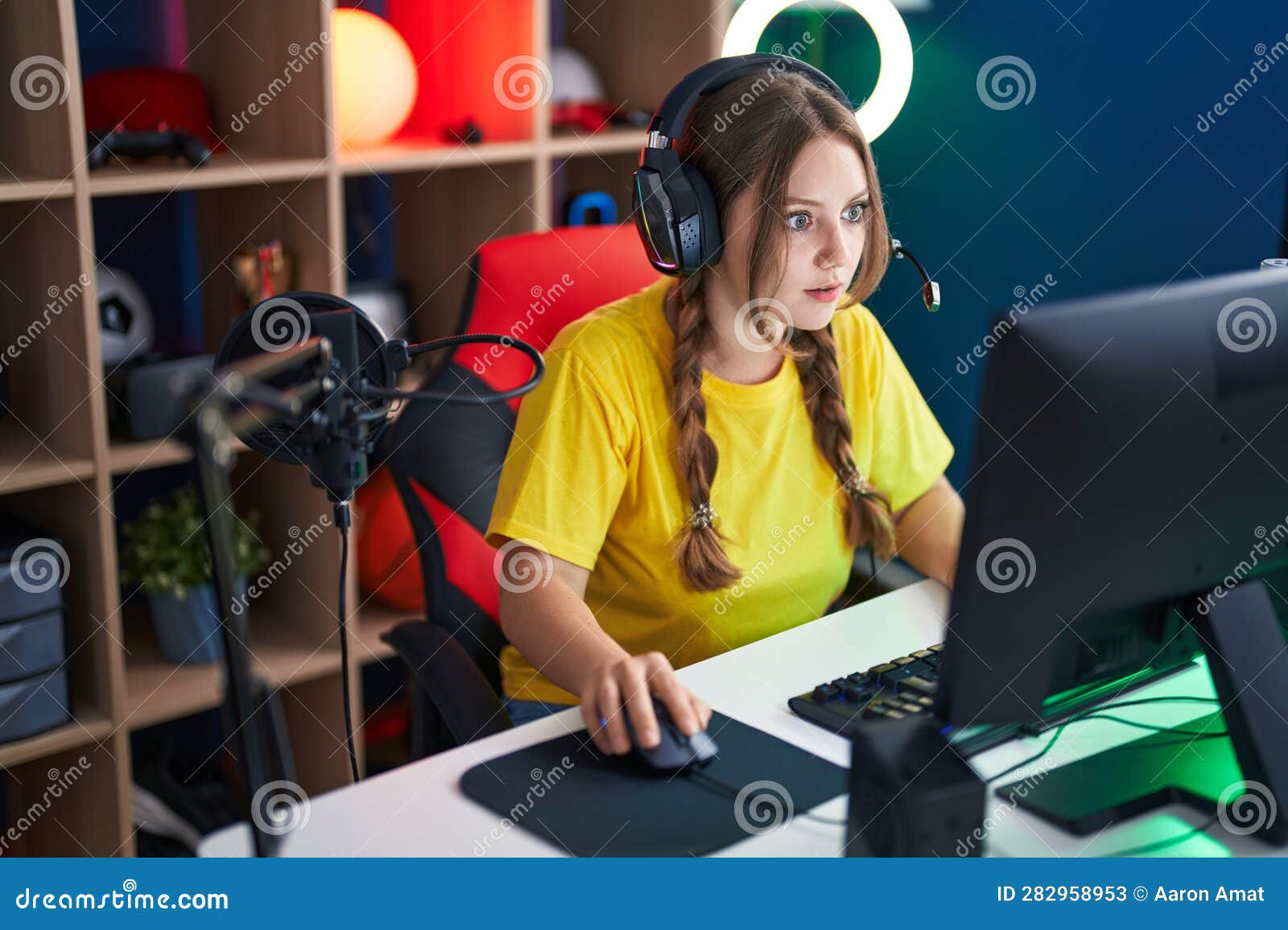 Young Blonde Woman Streamer Playing Video Game Using Computer at Gaming ...