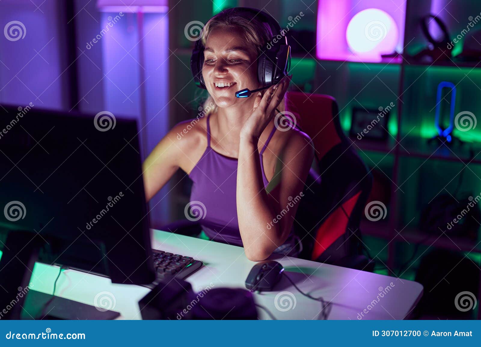 Young Blonde Woman Streamer Playing Video Game Using Computer at Gaming ...