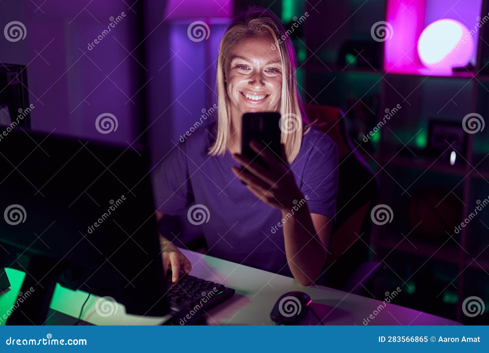 Young Blonde Woman Streamer Using Computer and Smarpthone at Gaming ...