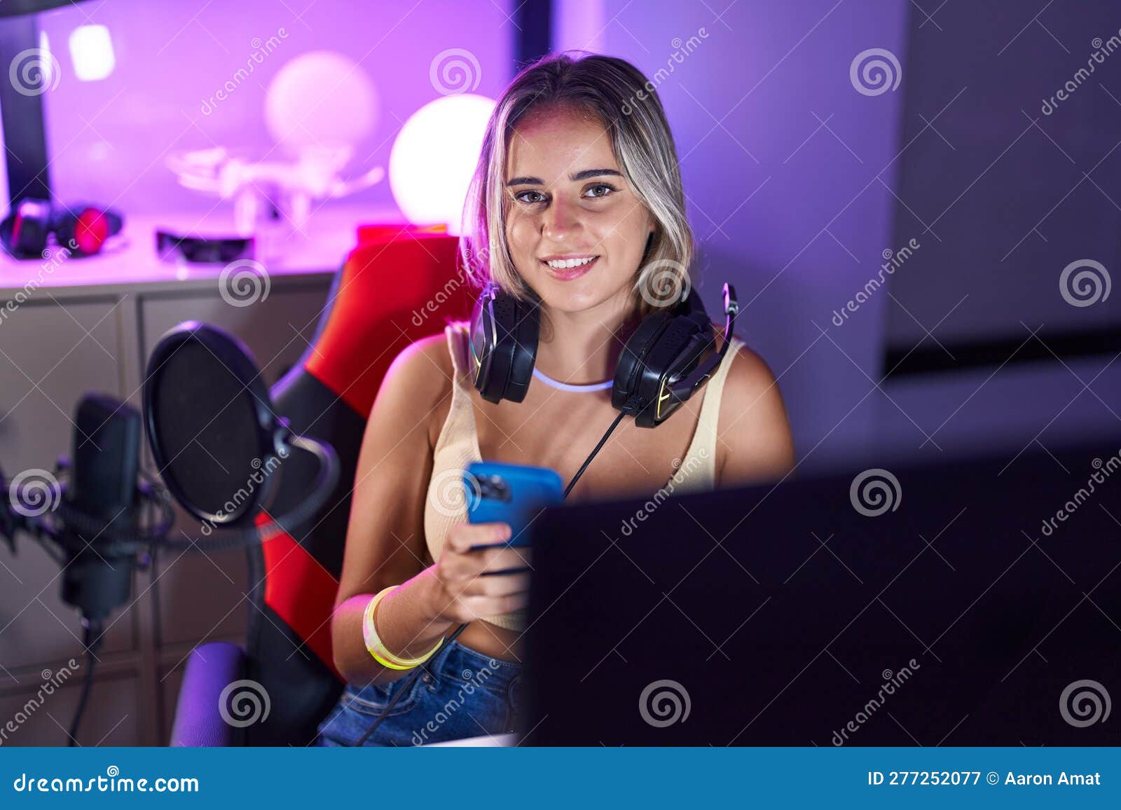 Young Blonde Woman Streamer Using Computer and Smartphone at Gaming ...