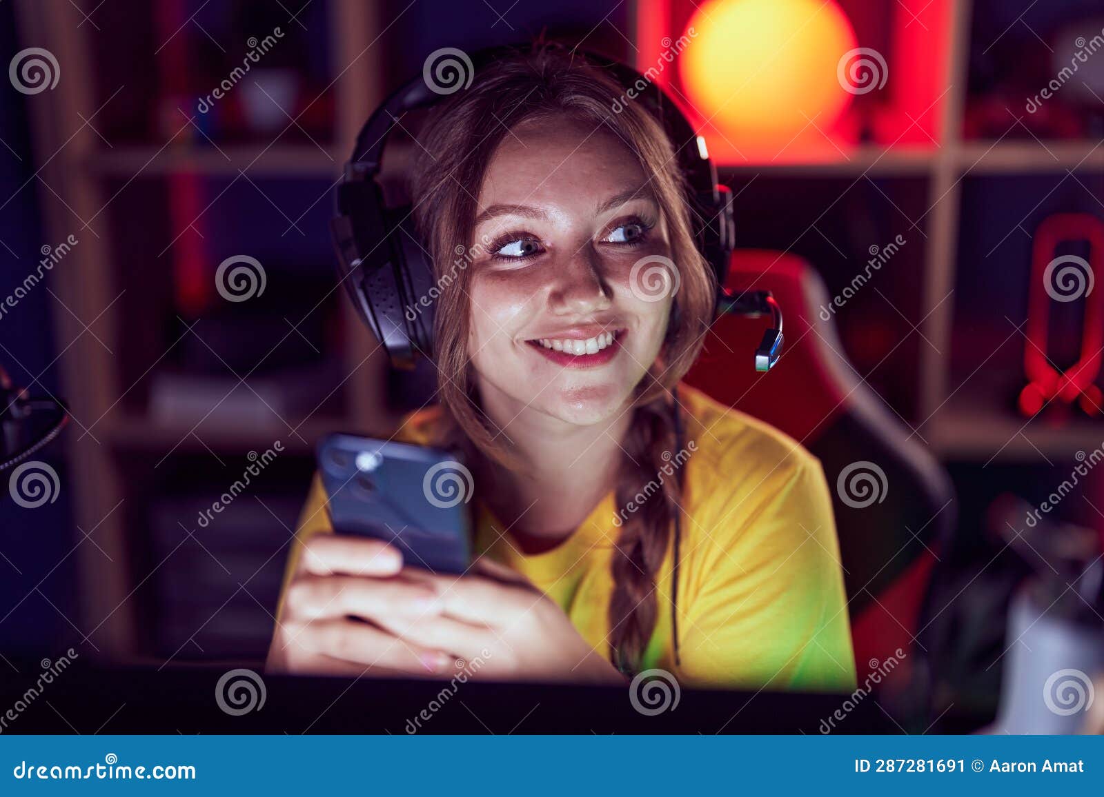 Young Blonde Woman Streamer Using Computer and Smartphone at Gaming ...