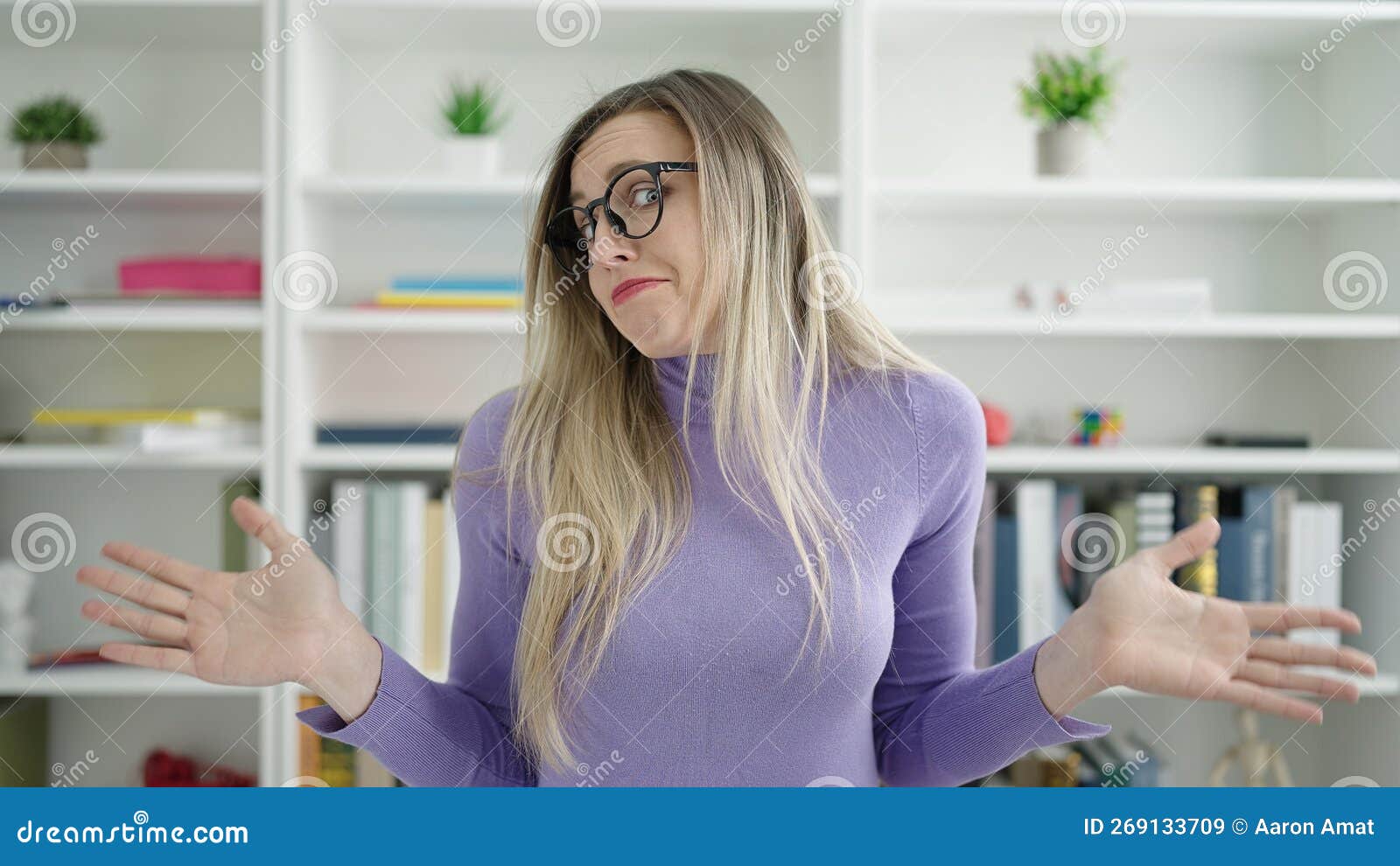 Young Blonde Woman Student Standing with I Dont Know Expression at Library University Stock ...