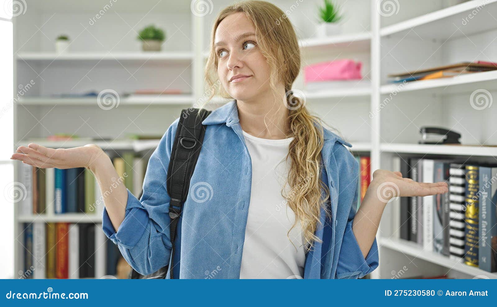 Young Blonde Woman Student Standing with I Dont Know Expression at ...