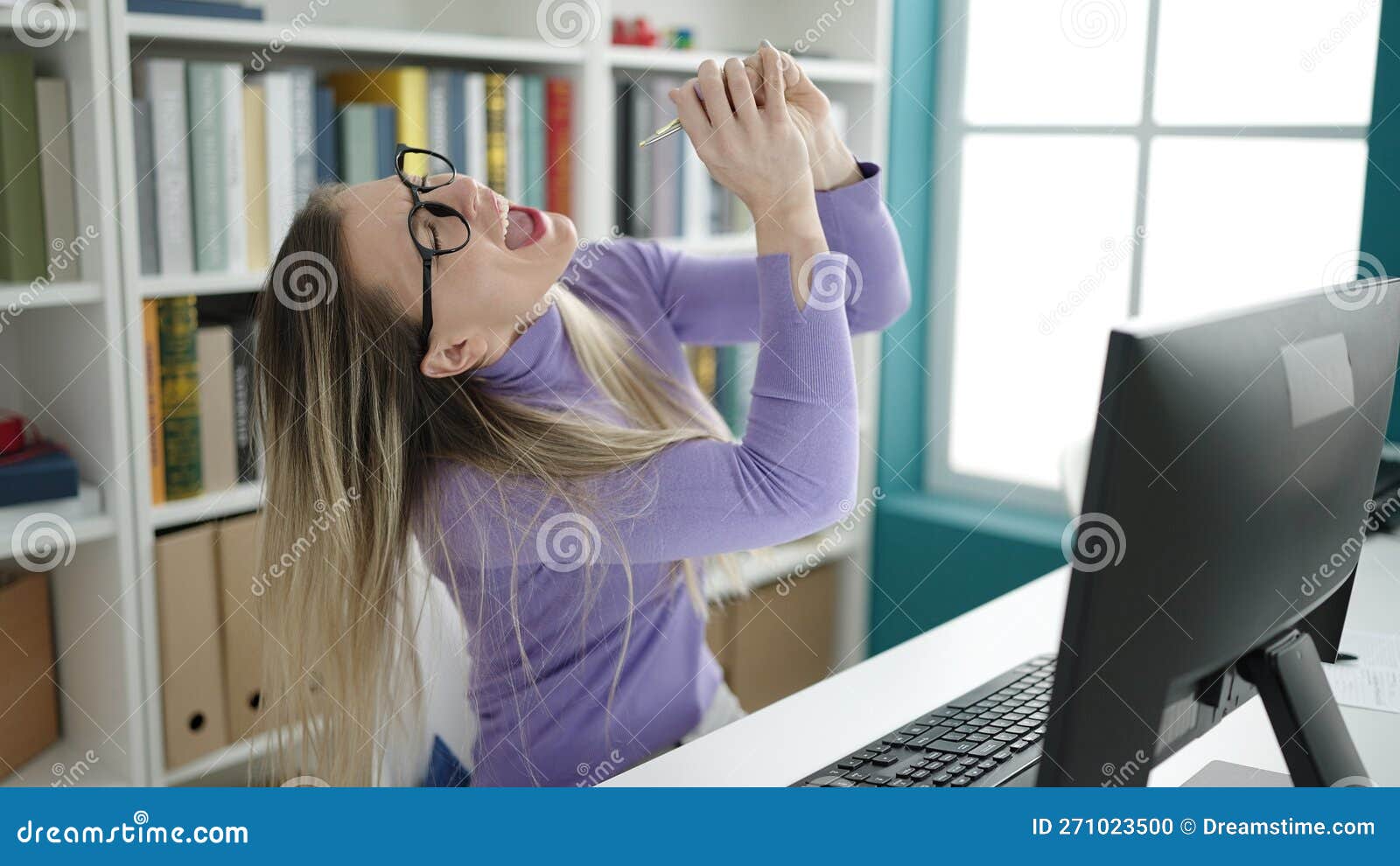 Young Blonde Woman Student Using Computer Singing Song at Library ...