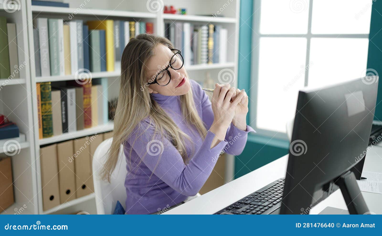 Young Blonde Woman Student Using Computer Singing Song at Library ...