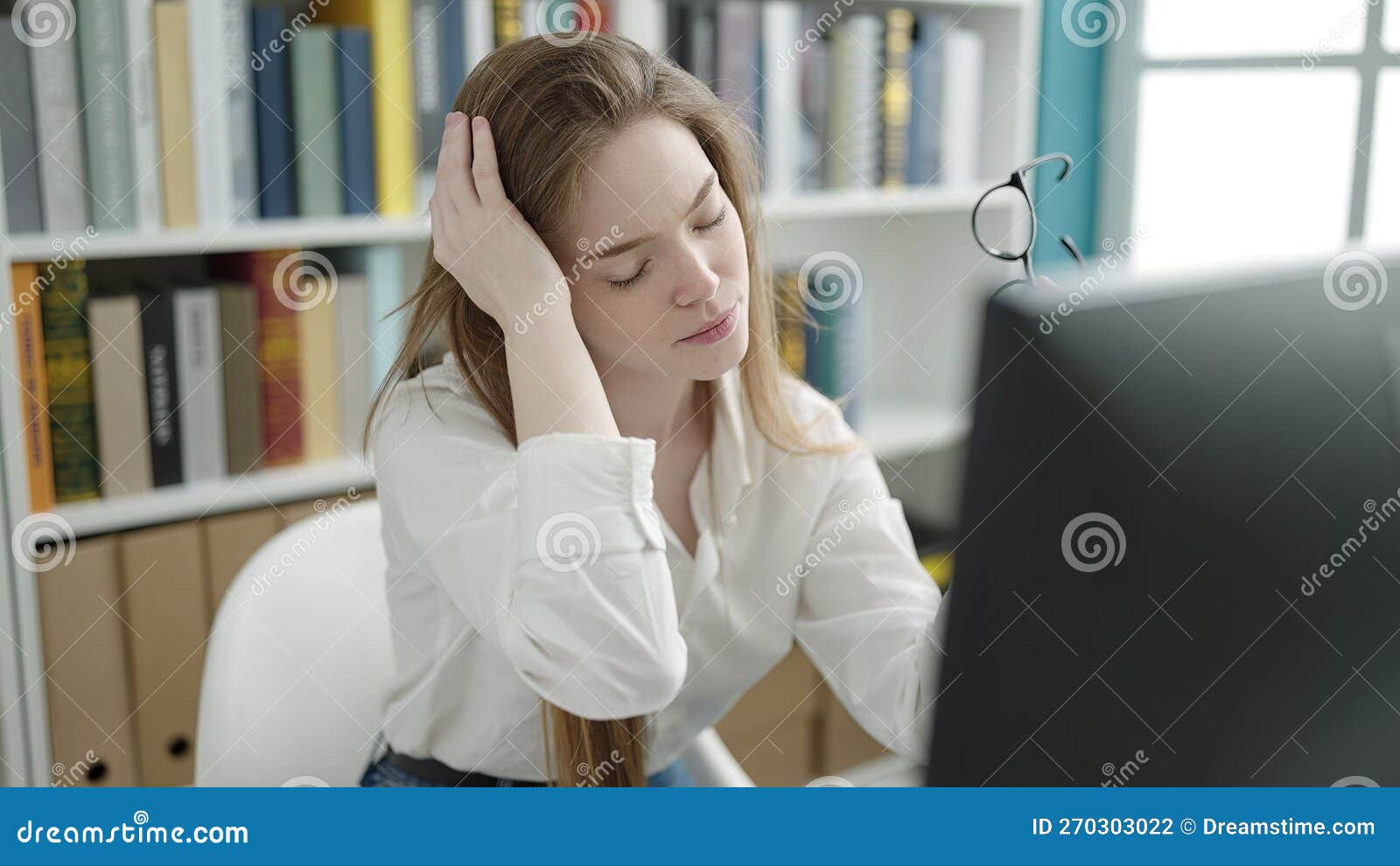Young Blonde Woman Student Using Computer Stressed at University ...