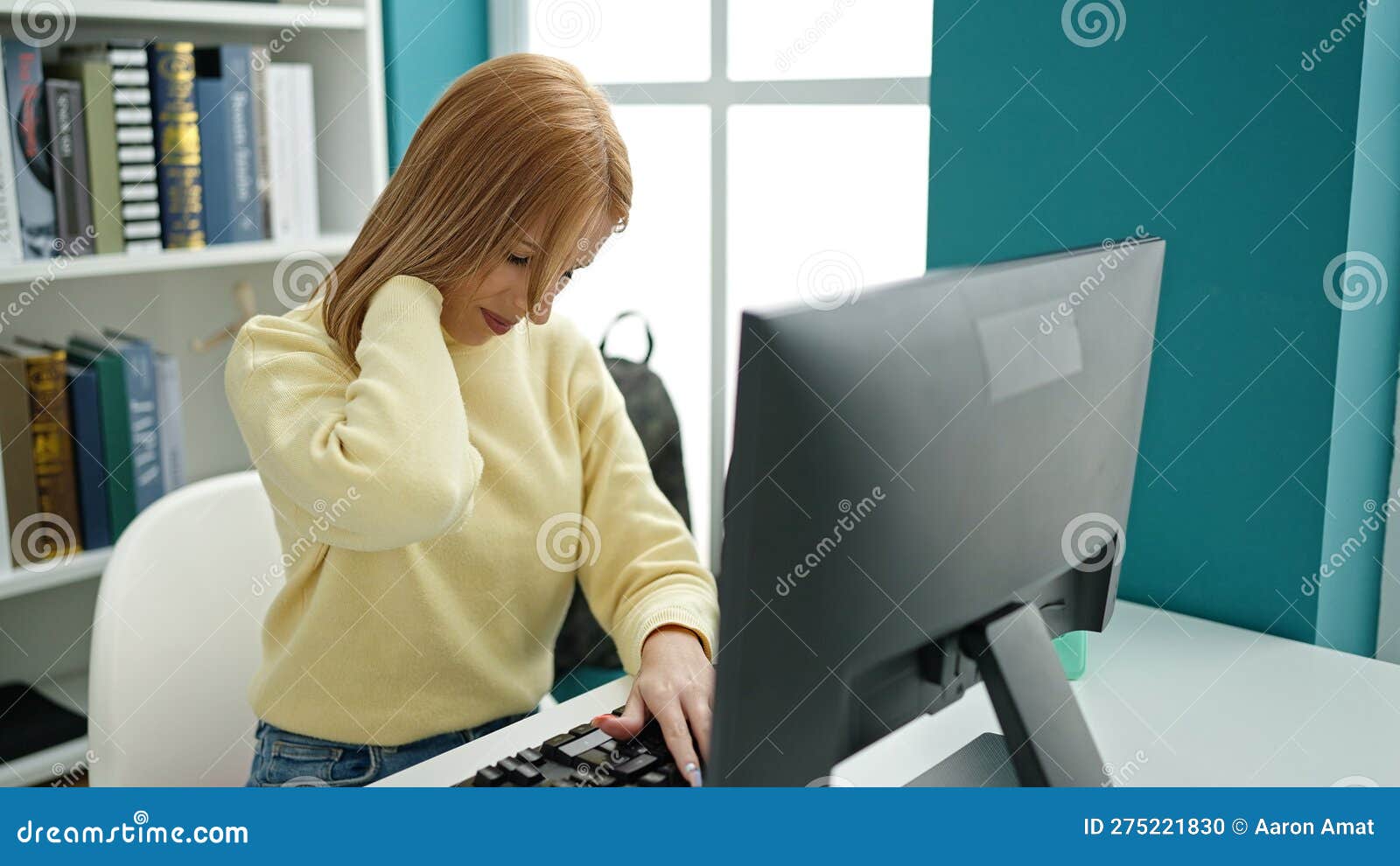 Young Blonde Woman Student Using Computer Stressed at University ...