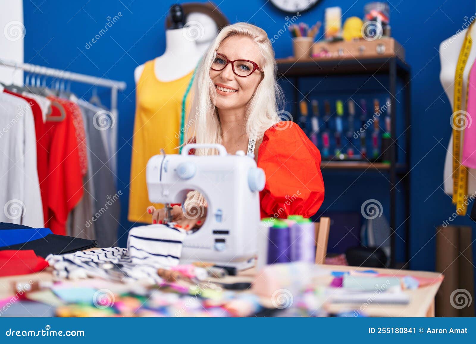 Young Blonde Woman Tailor Smiling Confident Using Sewing Machine at ...