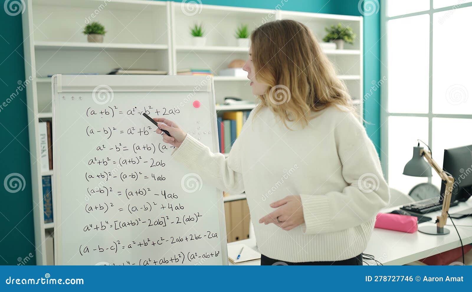 Young Blonde Woman Teacher Explaining Maths Exercise at University ...