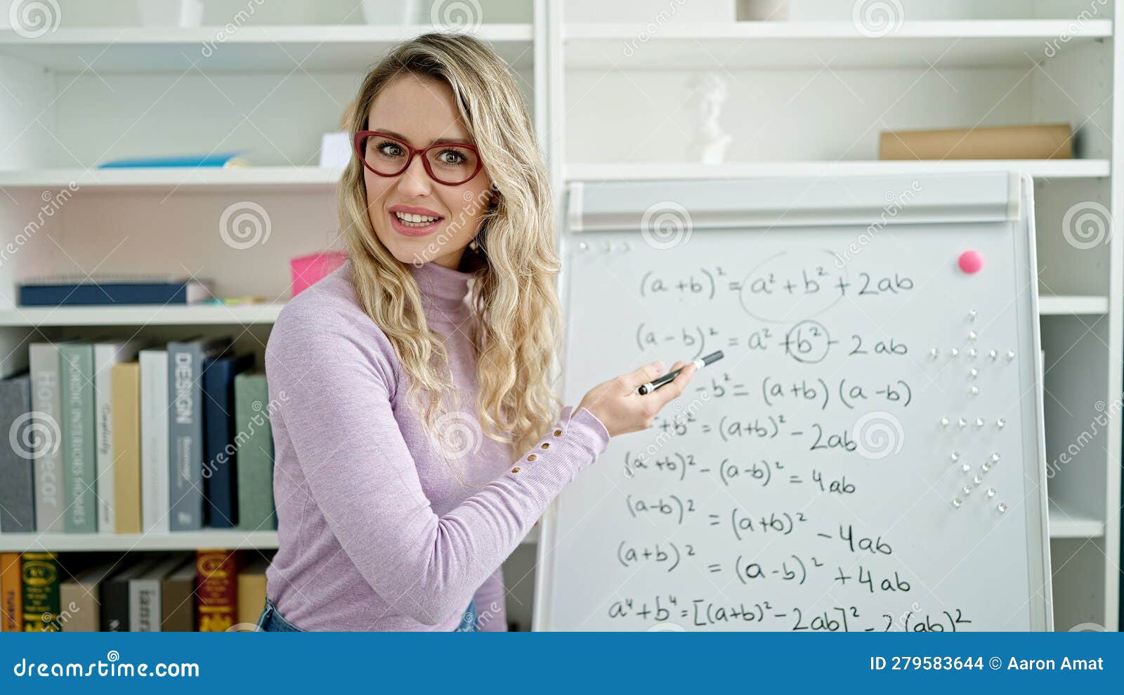 Young Blonde Woman Teacher Teaching Maths Lesson at Classroom Stock ...