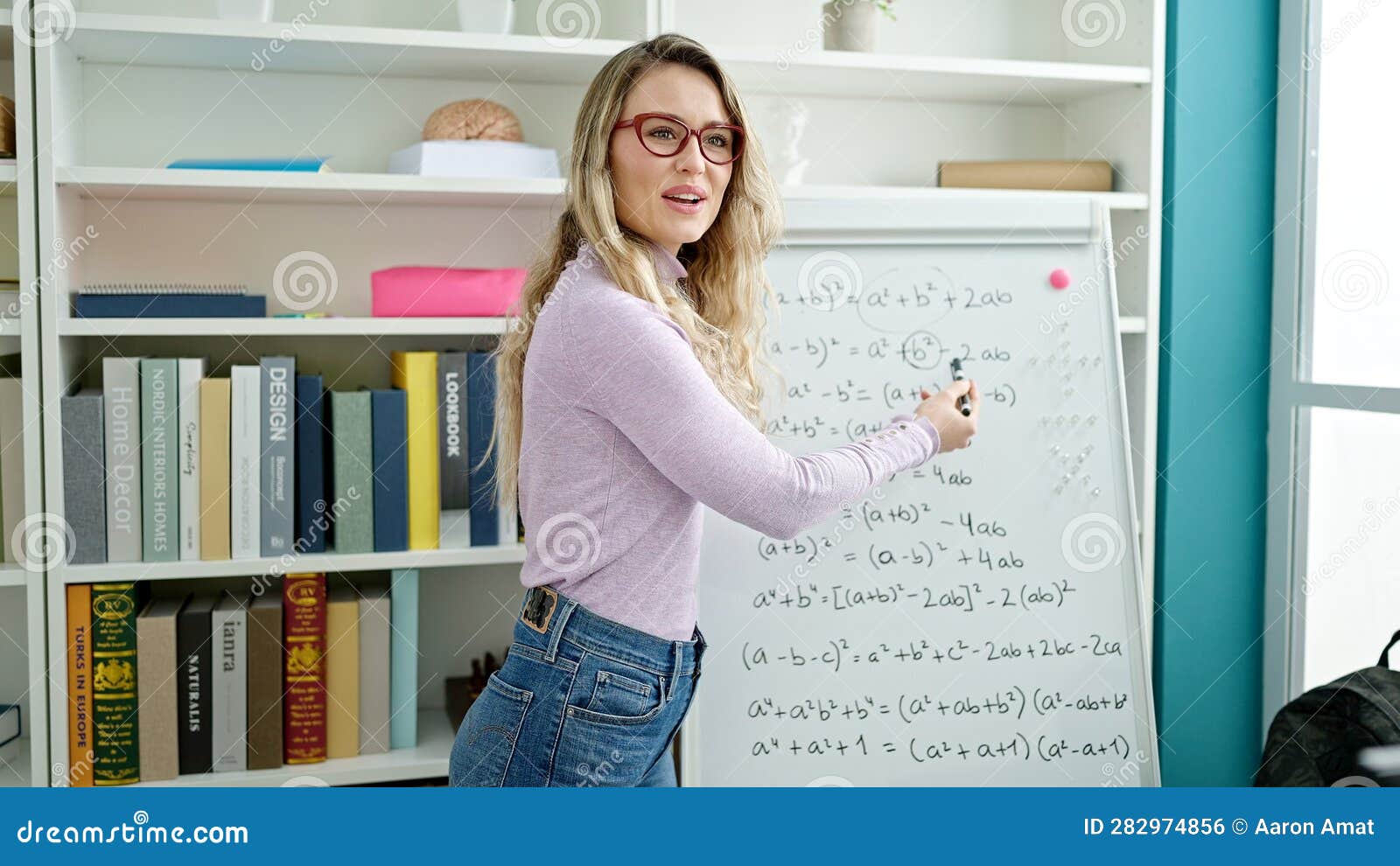Young Blonde Woman Teacher Teaching Maths Lesson at Classroom Stock ...