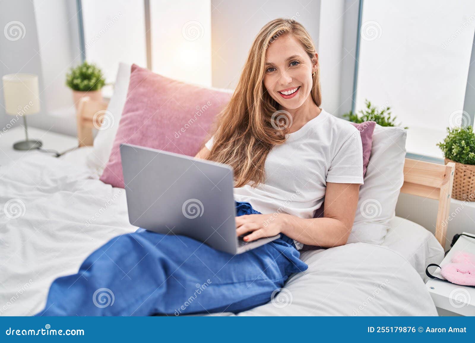 Young Blonde Woman Using Laptop Lying on Bed at Bedroom Stock Photo ...