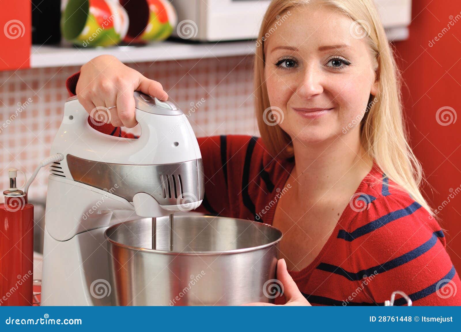 Young Blonde Woman Using a Mixer in Red Kitchen. Stock Photo - Image of ...