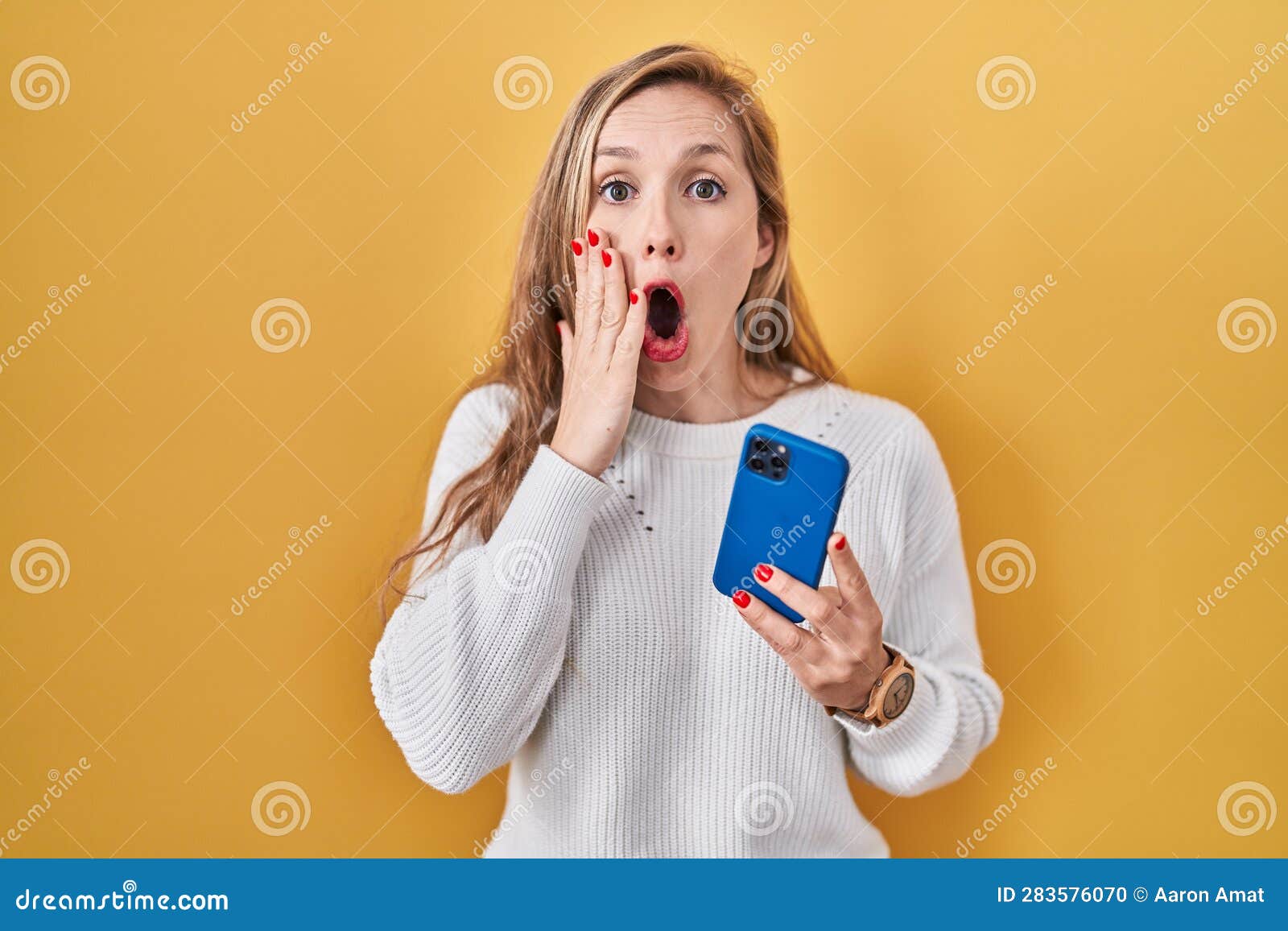 Young Blonde Woman Using Smartphone Typing Message Afraid and Shocked ...