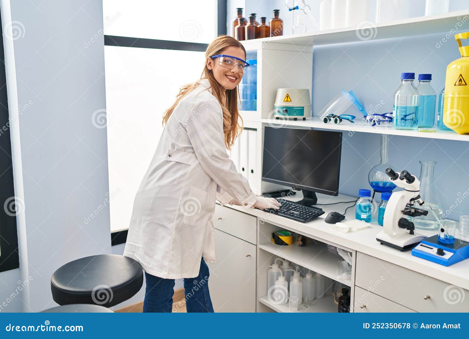 Young Blonde Woman Wearing Scientist Uniform Using Computer at ...