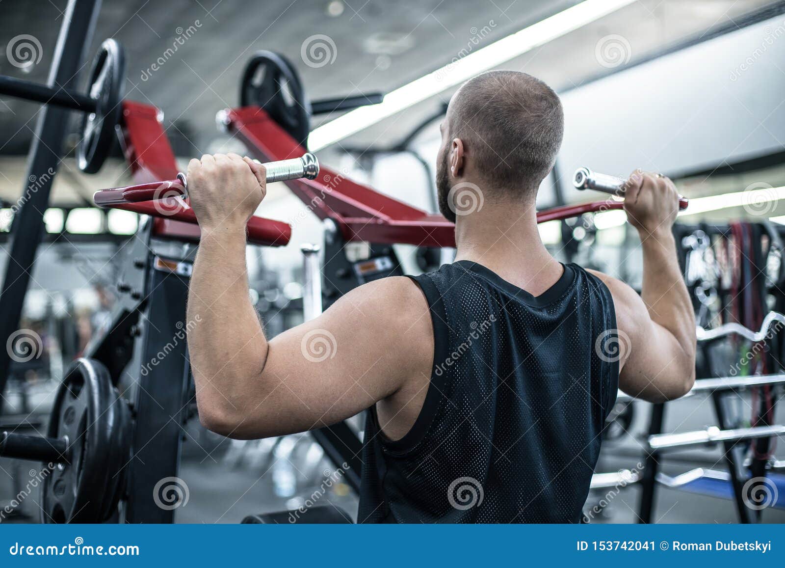 Young Bodybuilder Doing Heavy Weight Exercise for Back on Machine Stock ...