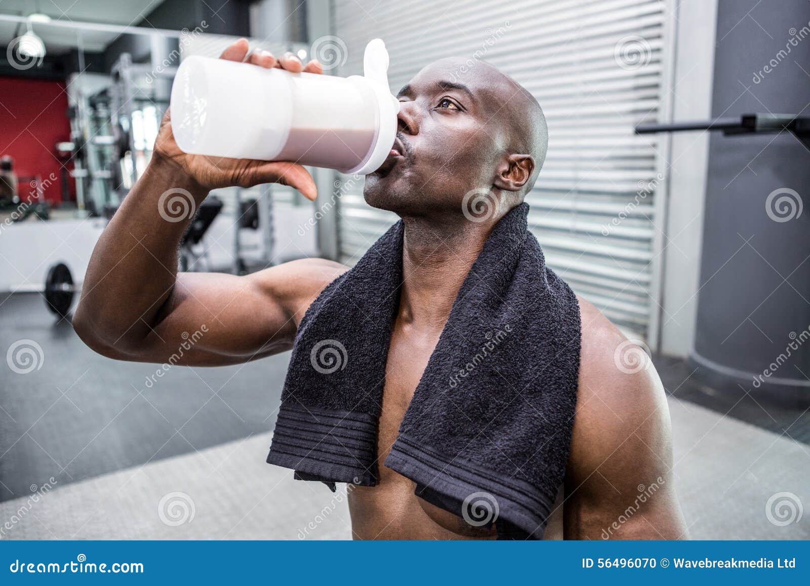 Young Bodybuilder Drinking a Bottle of Water after the Training Stock ...