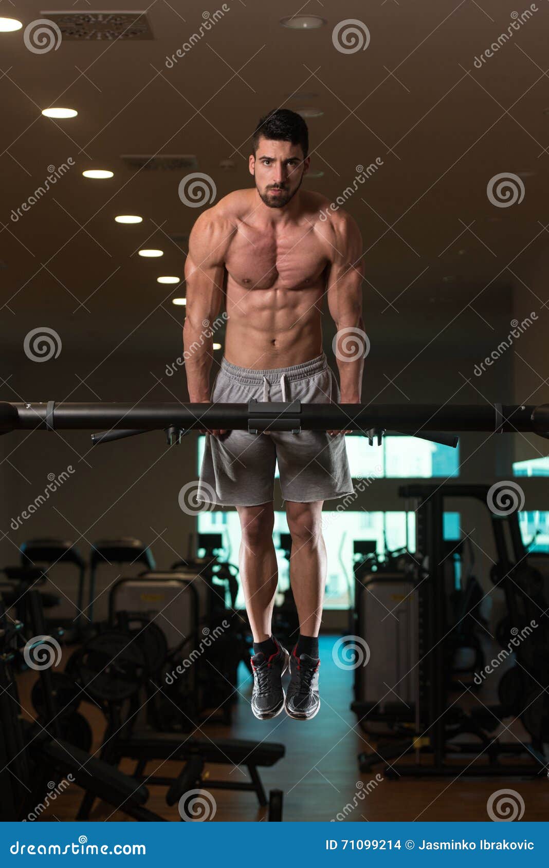 Young Bodybuilder Exercising Triceps Doing Dips on Bar Stock Photo ...
