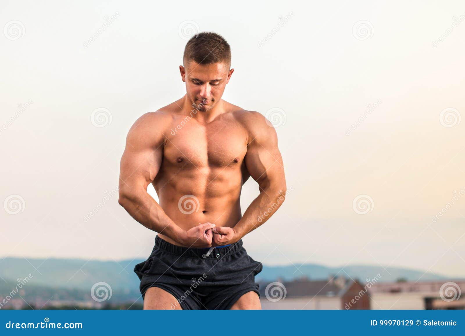 Bodybuilder Flexing Muscles on a Rooftop Stock Image - Image of ...