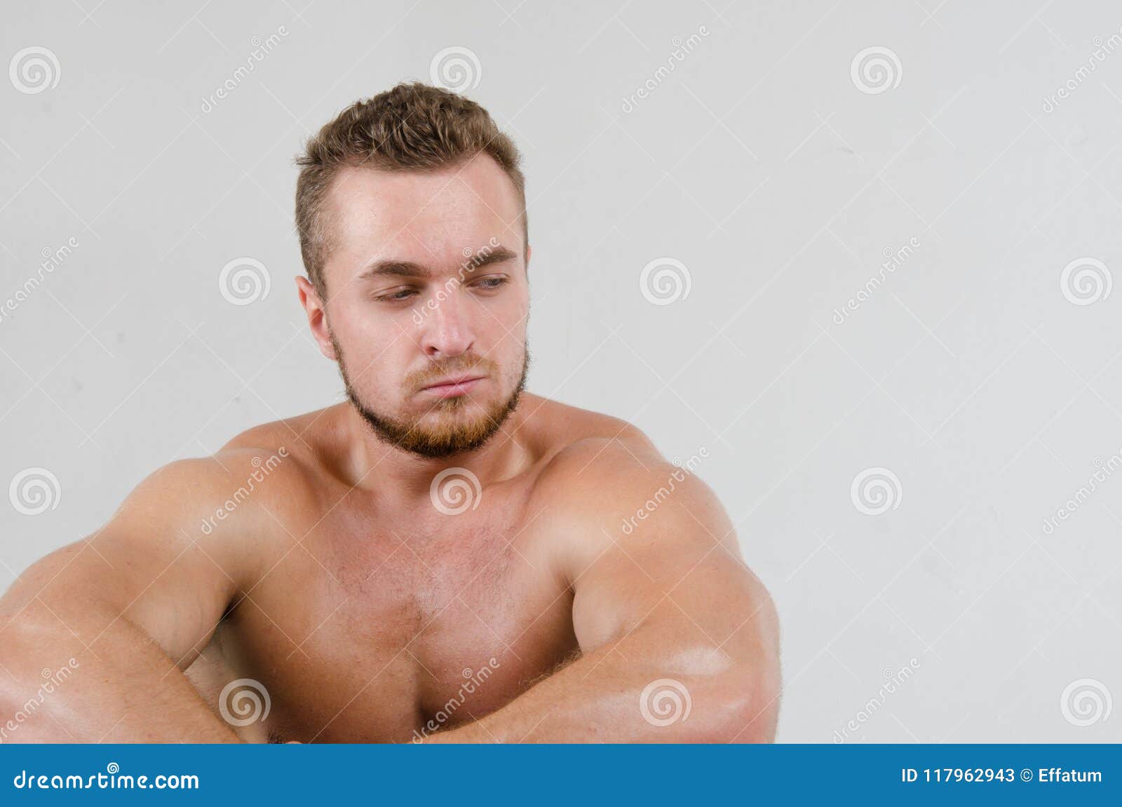 Young Bodybuilder Rests. Bodybuilder Sitting and Resting after Training ...