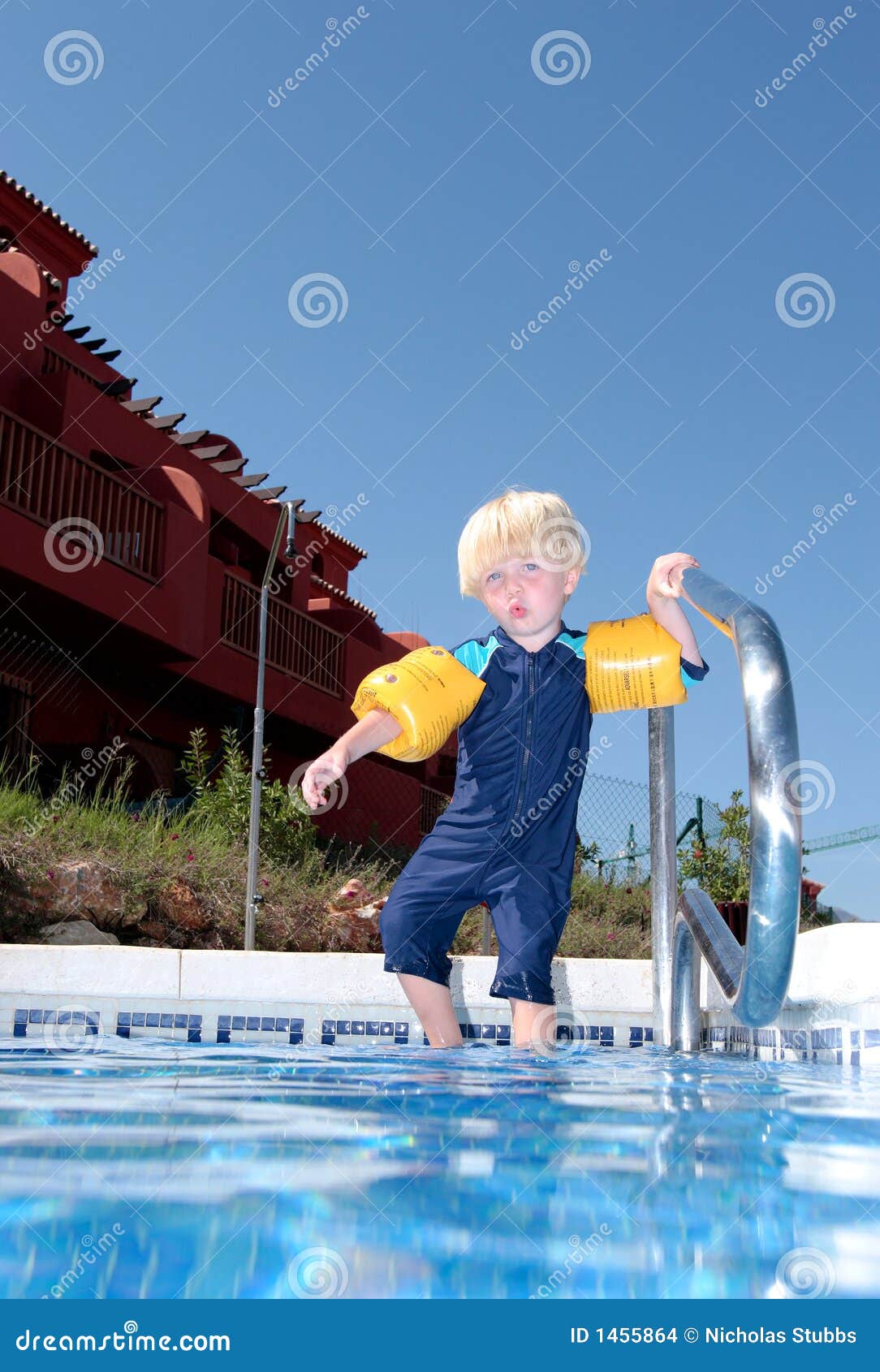 Young Boy with Arm Bands Climbing into Swimming Pool Stock Photo ...