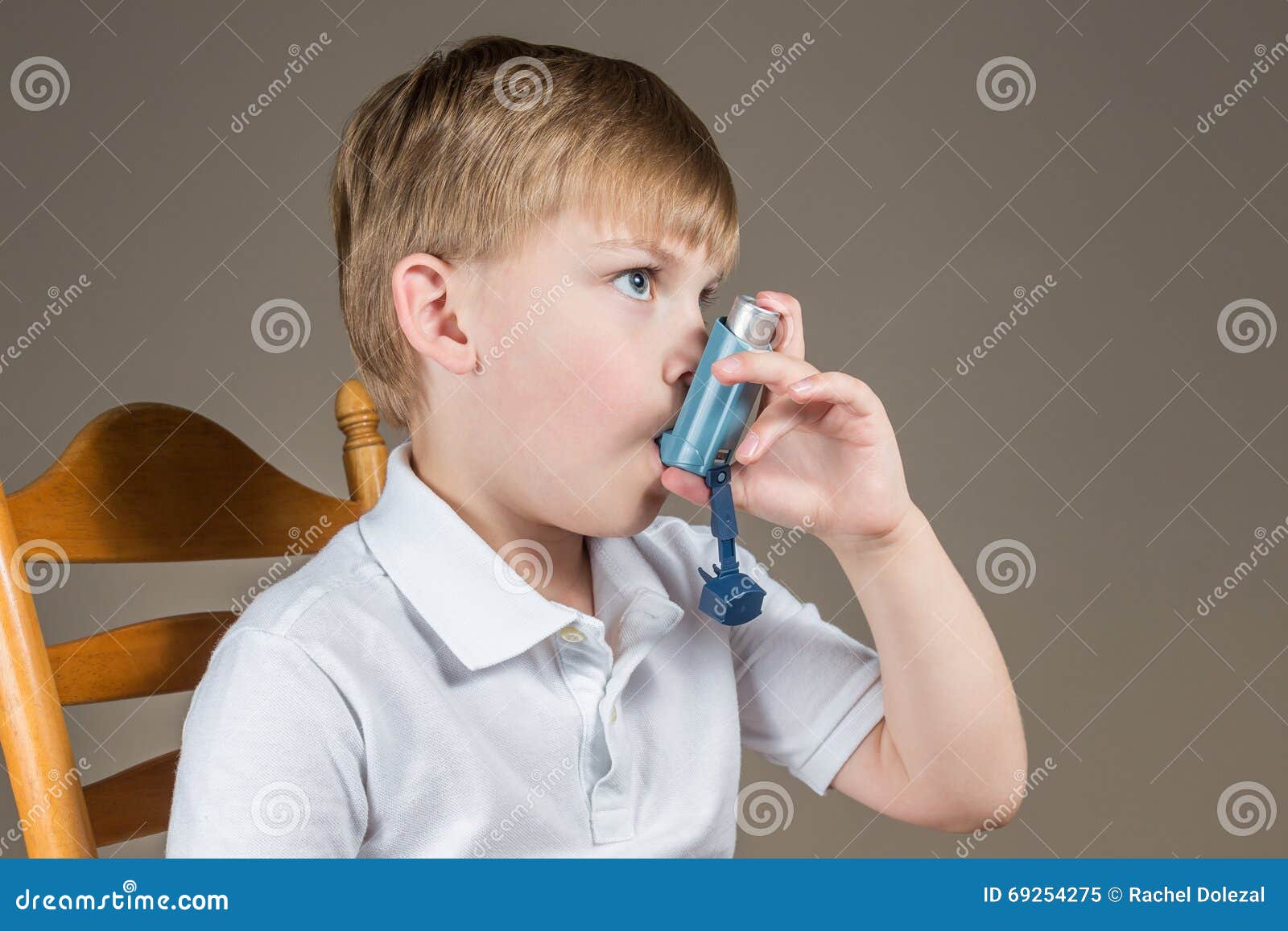 Young Boy with Asthma Using a Blue Inhaler Stock Image - Image of ...