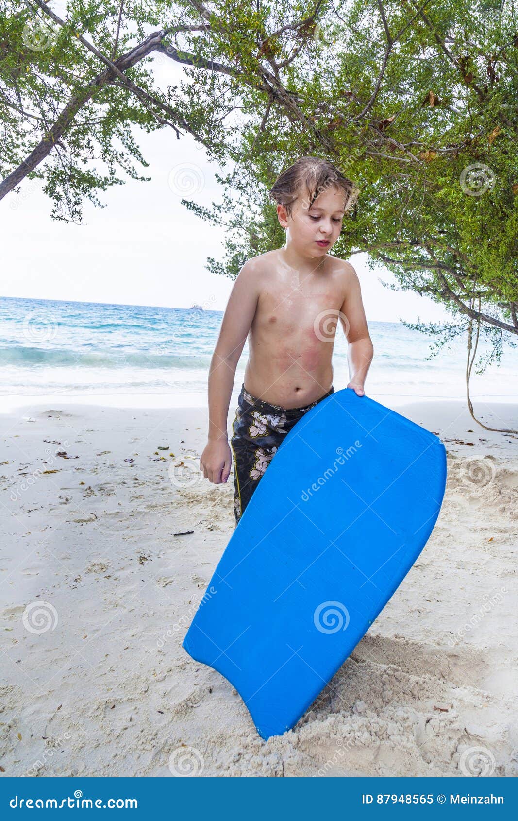 Young Boy at the Beach is Exhausted from Surfing Stock Image - Image of ...