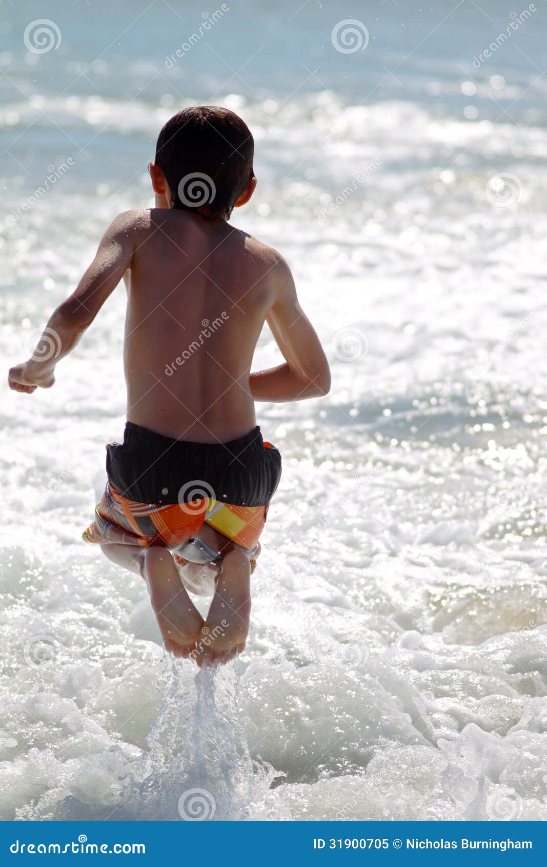 Young boy at the beach stock image. Image of sunny, waves - 31900705