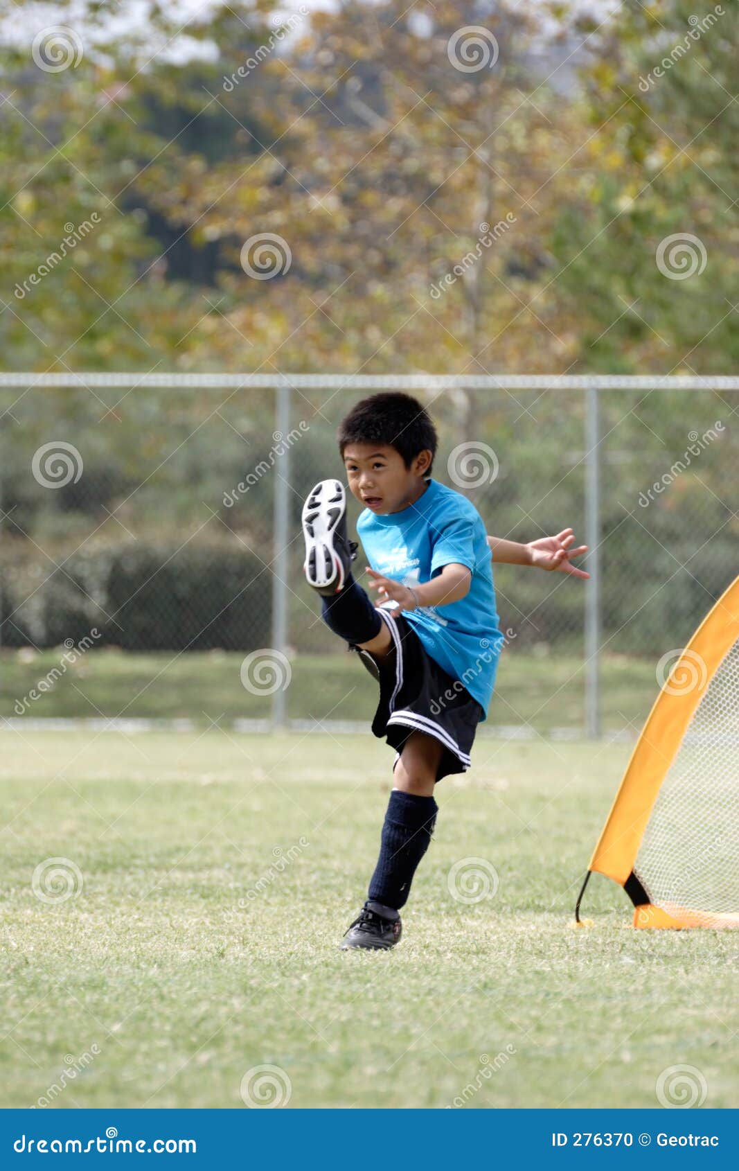 Young Boy with a Big Kick in Soccer Stock Photo - Image of play, field ...