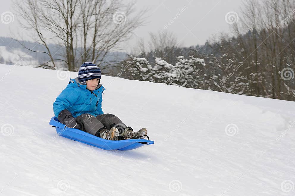 Young boy on blue sled stock photo. Image of baby, child - 23211504