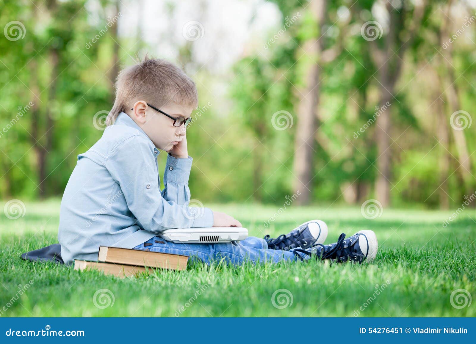 Young Boy with a Book and Laptop Computer Stock Image - Image of ...