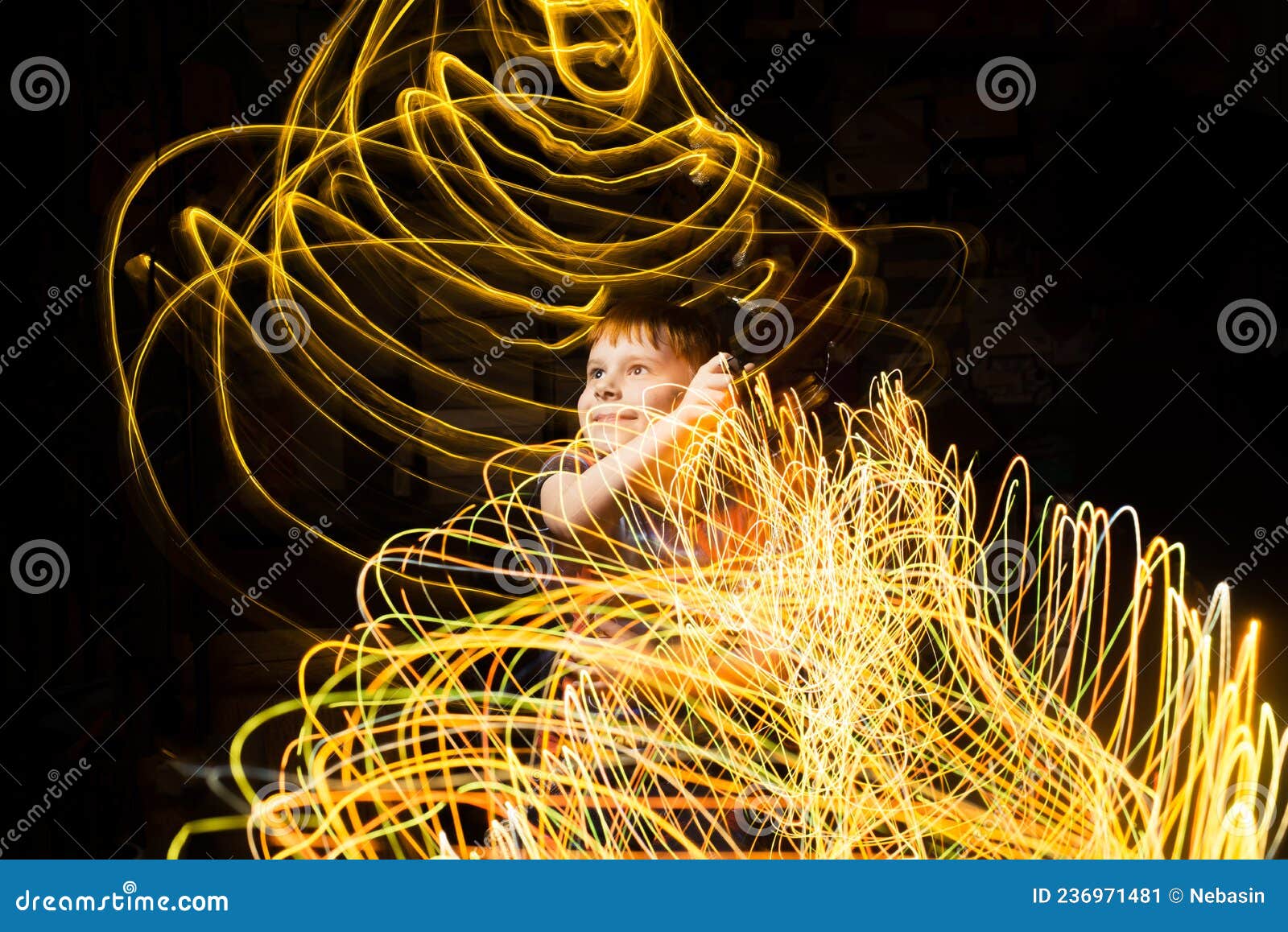 Young Boy in Bright Moving Abstract Lights Stock Image - Image of ...