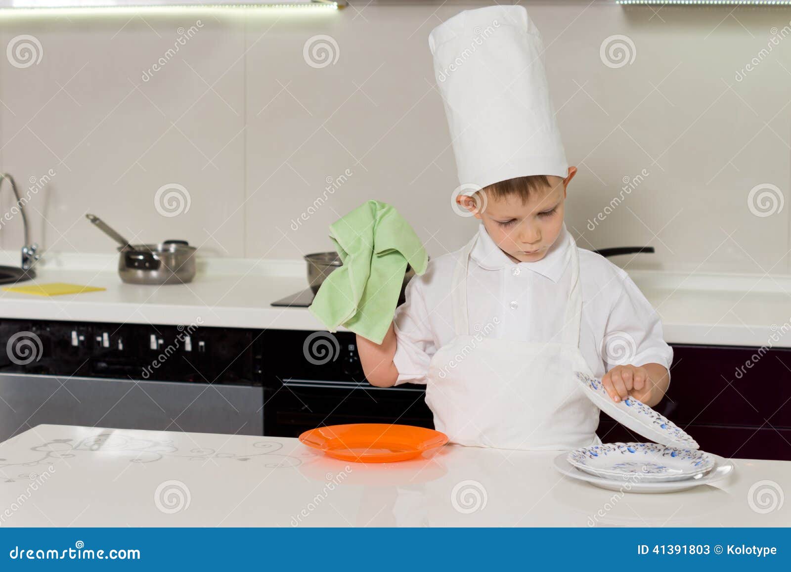 Young Boy In Chefs Uniform Washing The Dishes Royalty-Free Stock ...