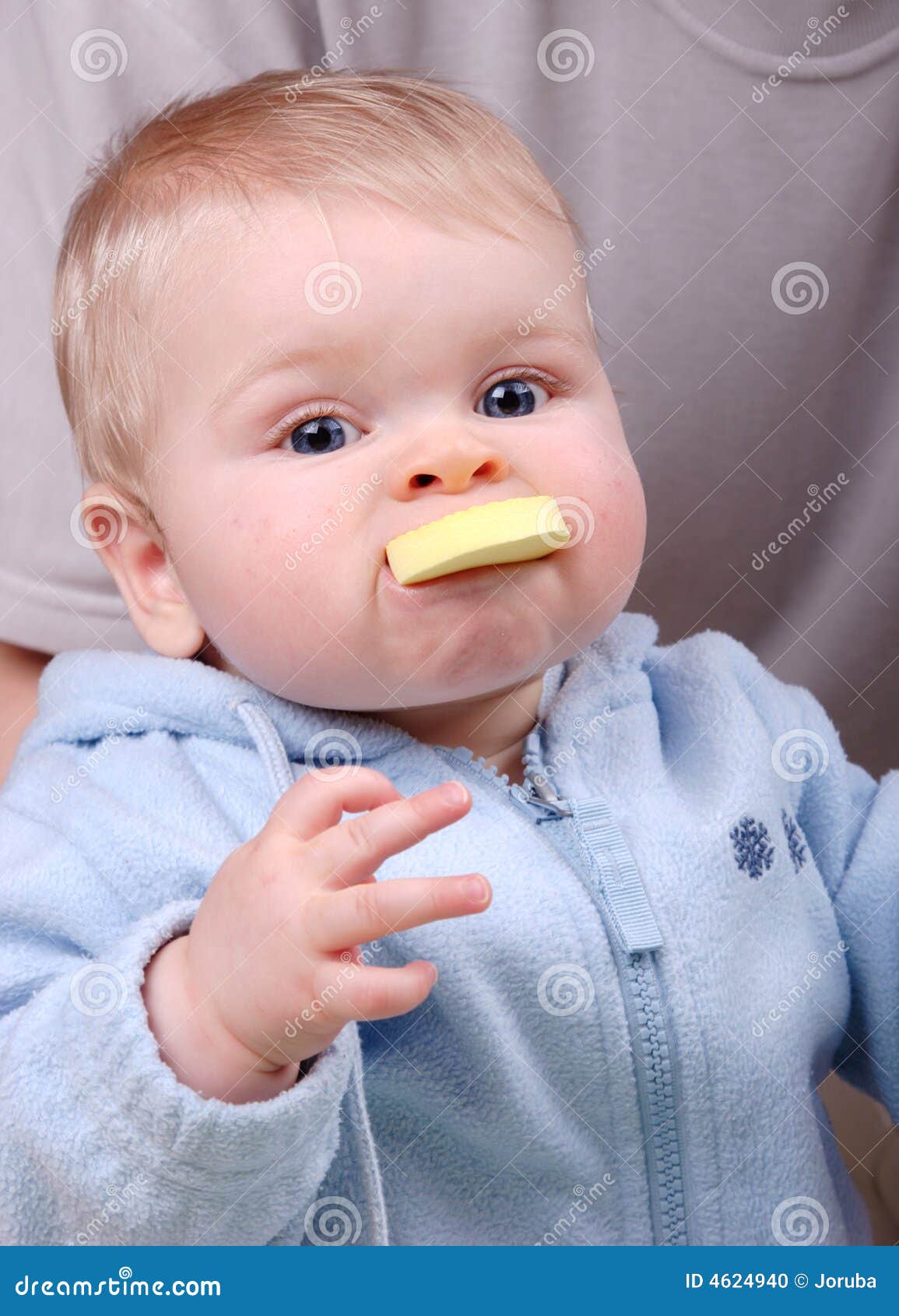 Young boy chew yellow toy stock photo. Image of dress - 4624940