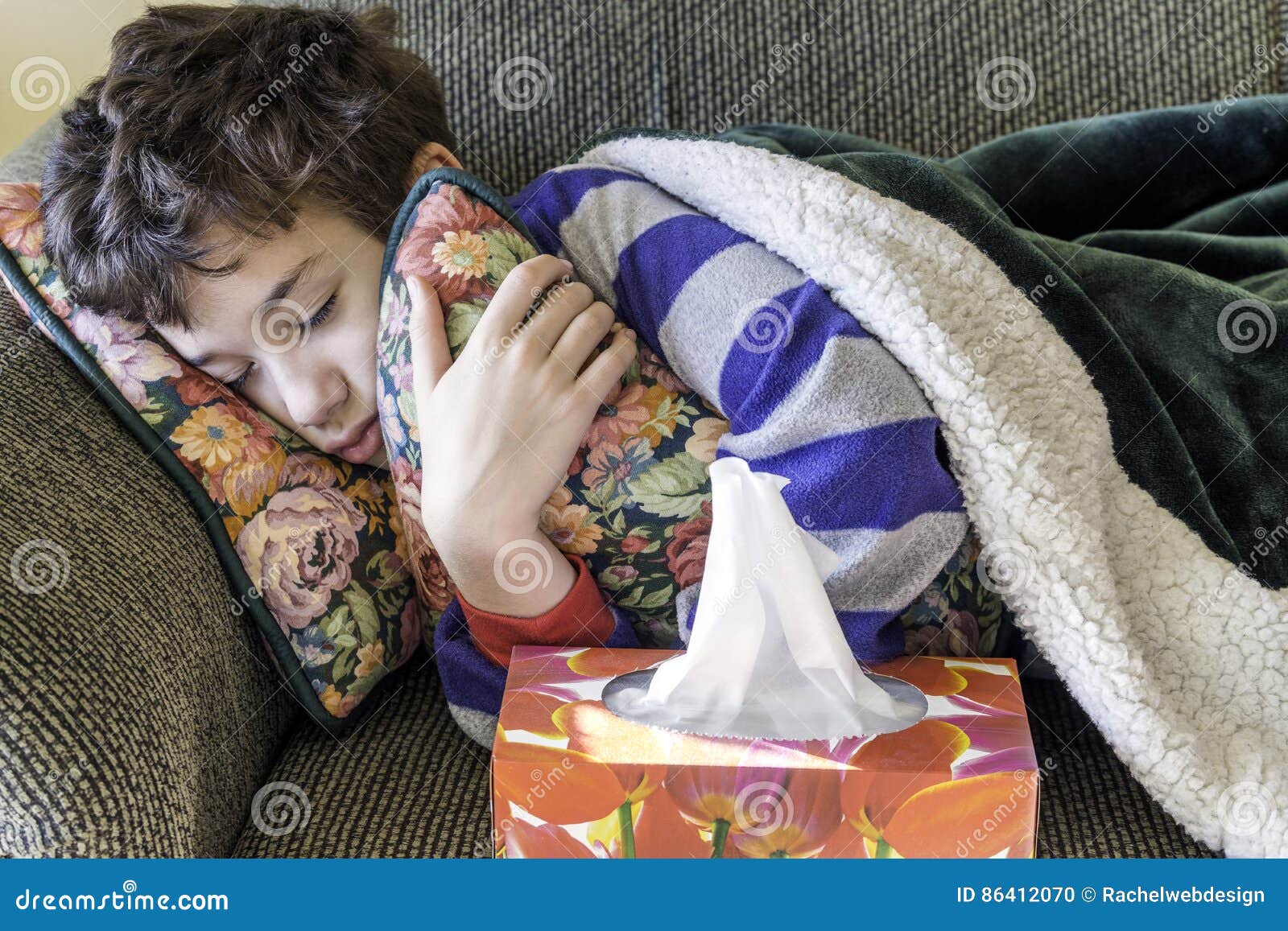 Young Boy with a Cold Flu Lying Down Sleeping on Couch and Hugging a ...