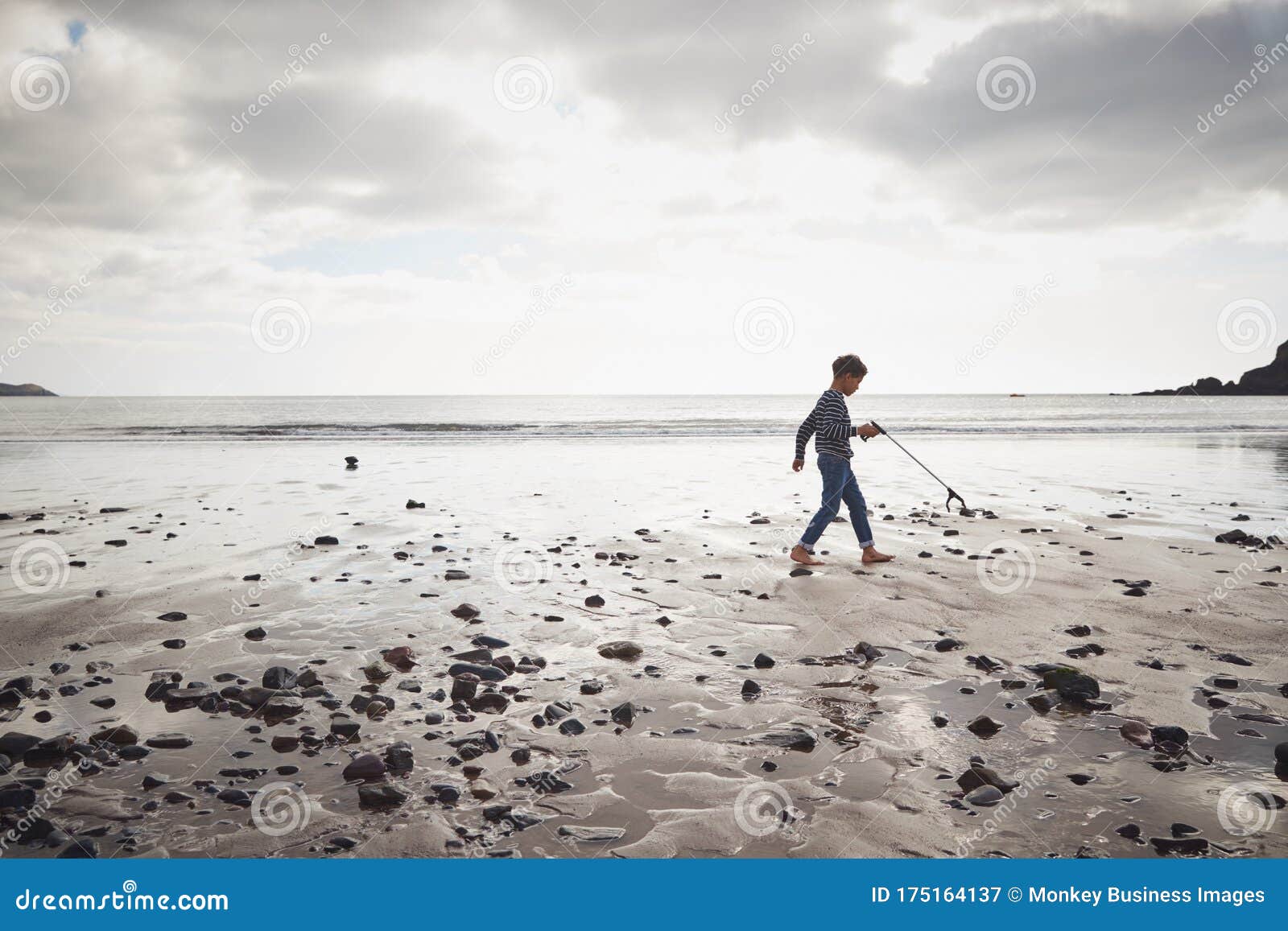 Young Boy Collecting Litter on Winter Beach Clean Up Stock Image ...