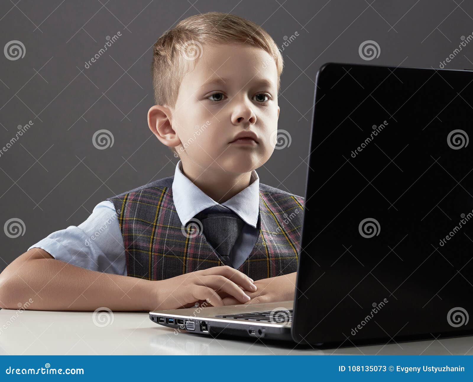 Young Boy with Computer. Child Looking in Notebook Stock Image - Image ...