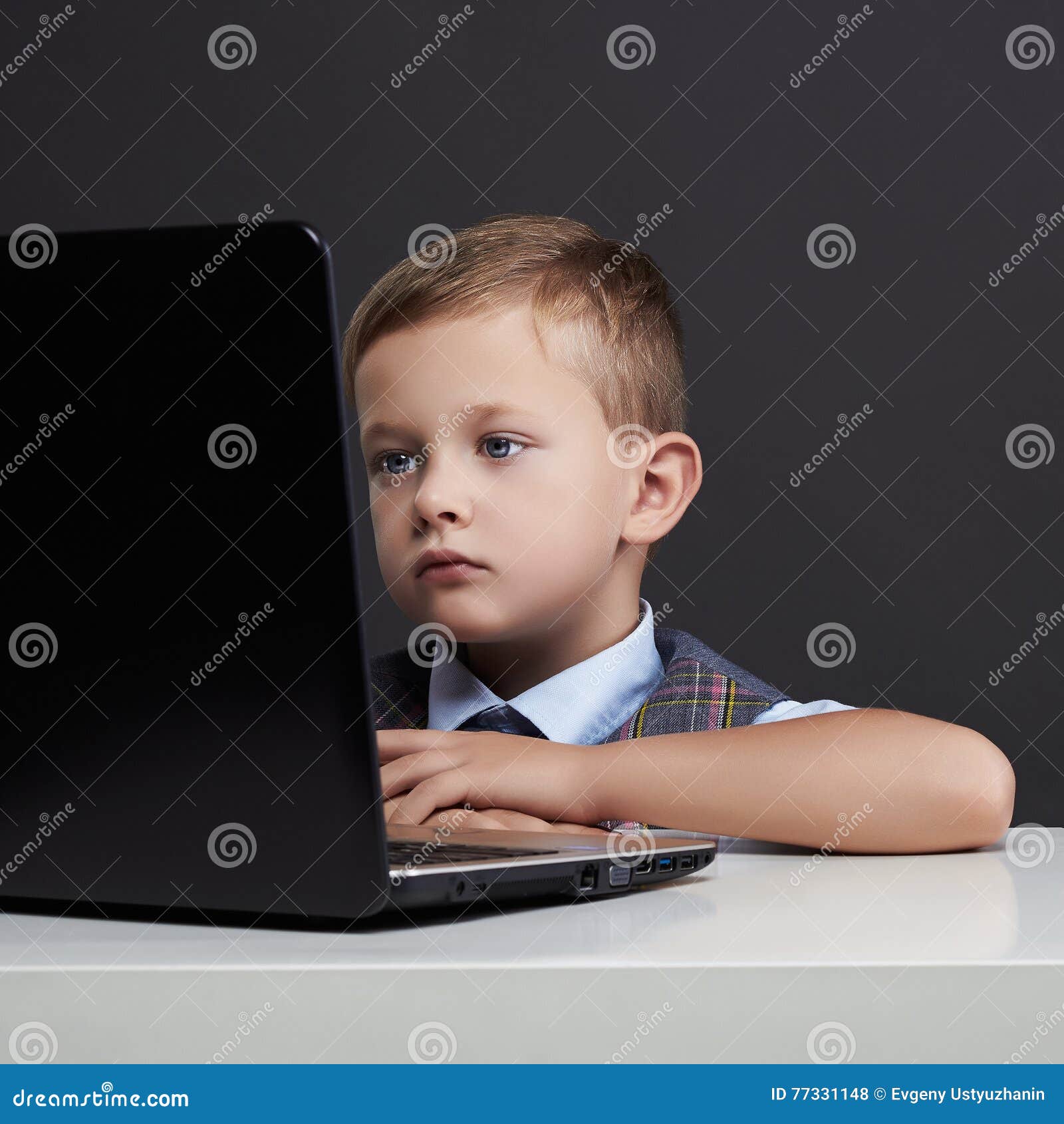 Young Boy with Computer. Funny Child Looking in Notebook Stock Photo ...