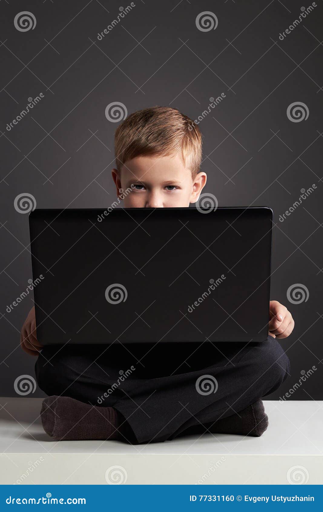 Young Boy with Computer. Funny Child Looking in Notebook Stock Photo ...